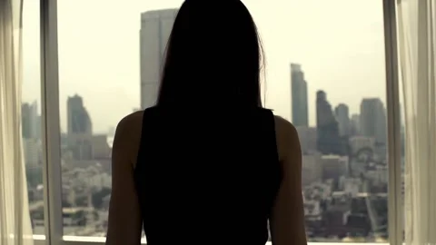 Young woman walking to the window and ad... | Stock Video | Pond5