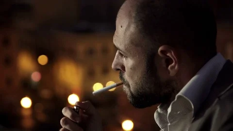 young worker smoking a cigarette watchin... | Stock Video | Pond5