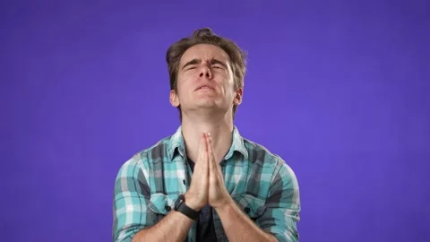 Young worried pleading man 20s hold hand... | Stock Video | Pond5