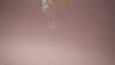Yuzu Fruit Splashing into Water with Pin... | Stock Video | Pond5