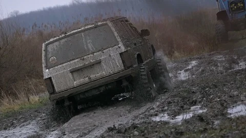 Zoom in on muddy off-road vehicle moving... | Stock Video | Pond5