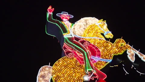 Zoom in on neon cowboy riding a horse si... | Stock Video | Pond5