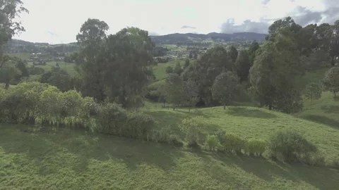 Zoom out landscape of hills, trees and b... | Stock Video | Pond5