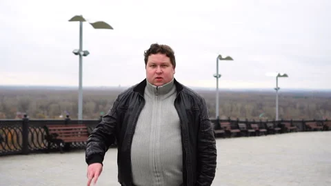 Zoom in portrait of fat man looking at c... | Stock Video | Pond5