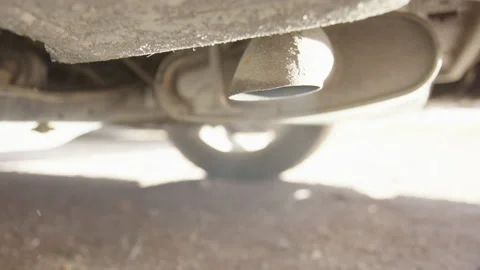 ZOOM IN - A smoking exhaust tailpipe, of... | Stock Video | Pond5