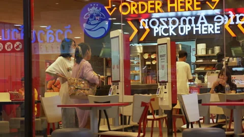 Zooming out of the customers inside KFC ... | Stock Video | Pond5