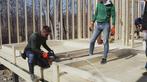 Zooming out view of builder with nailing... | Stock Video | Pond5